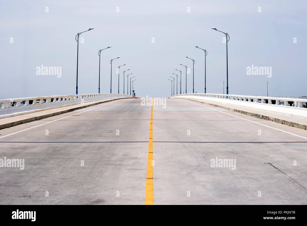 Slope of concrete road and clear sky background Stock Photo - Alamy