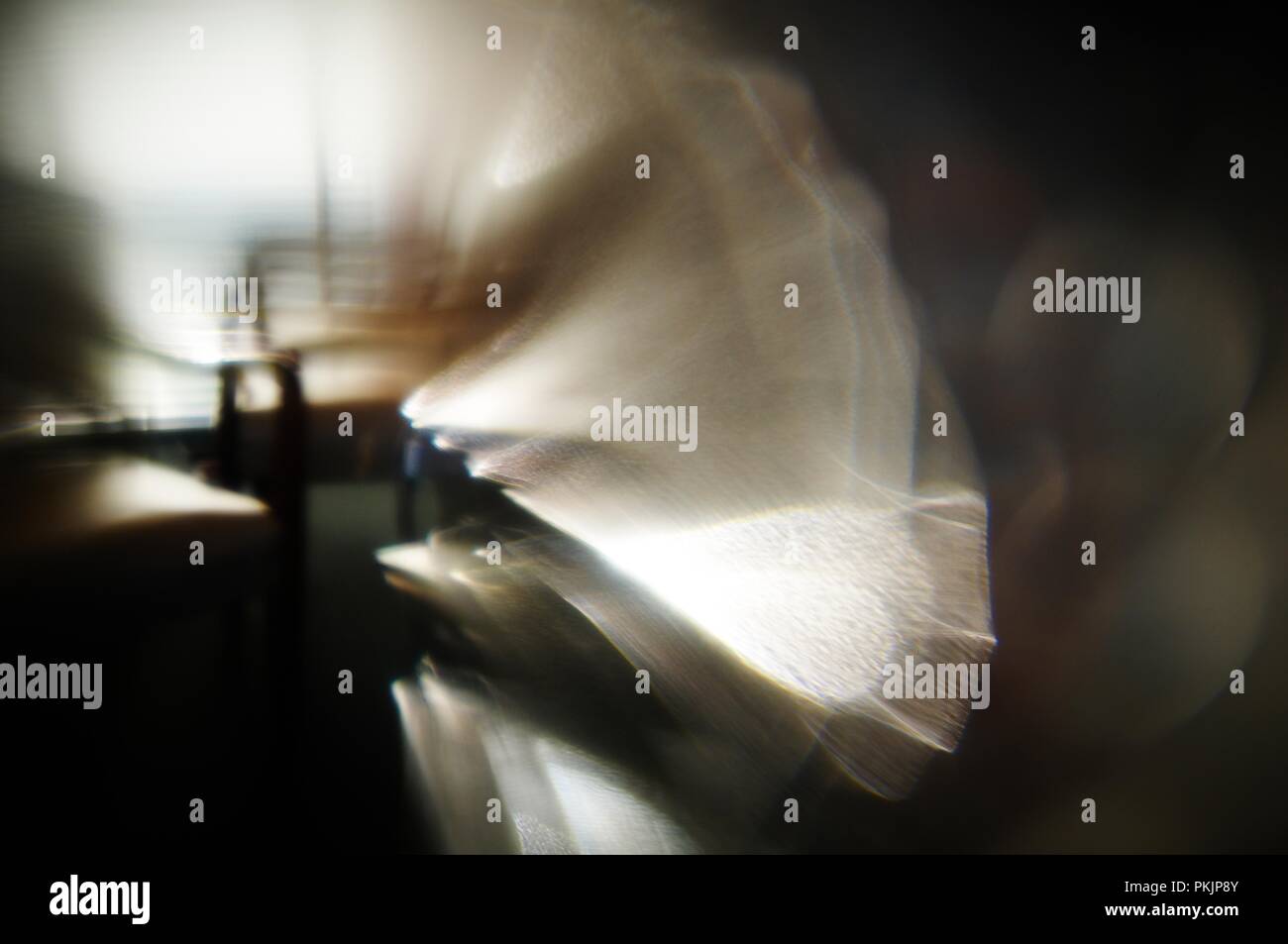 Abstract of an antique chair with venetian blind shadows across it shot ...