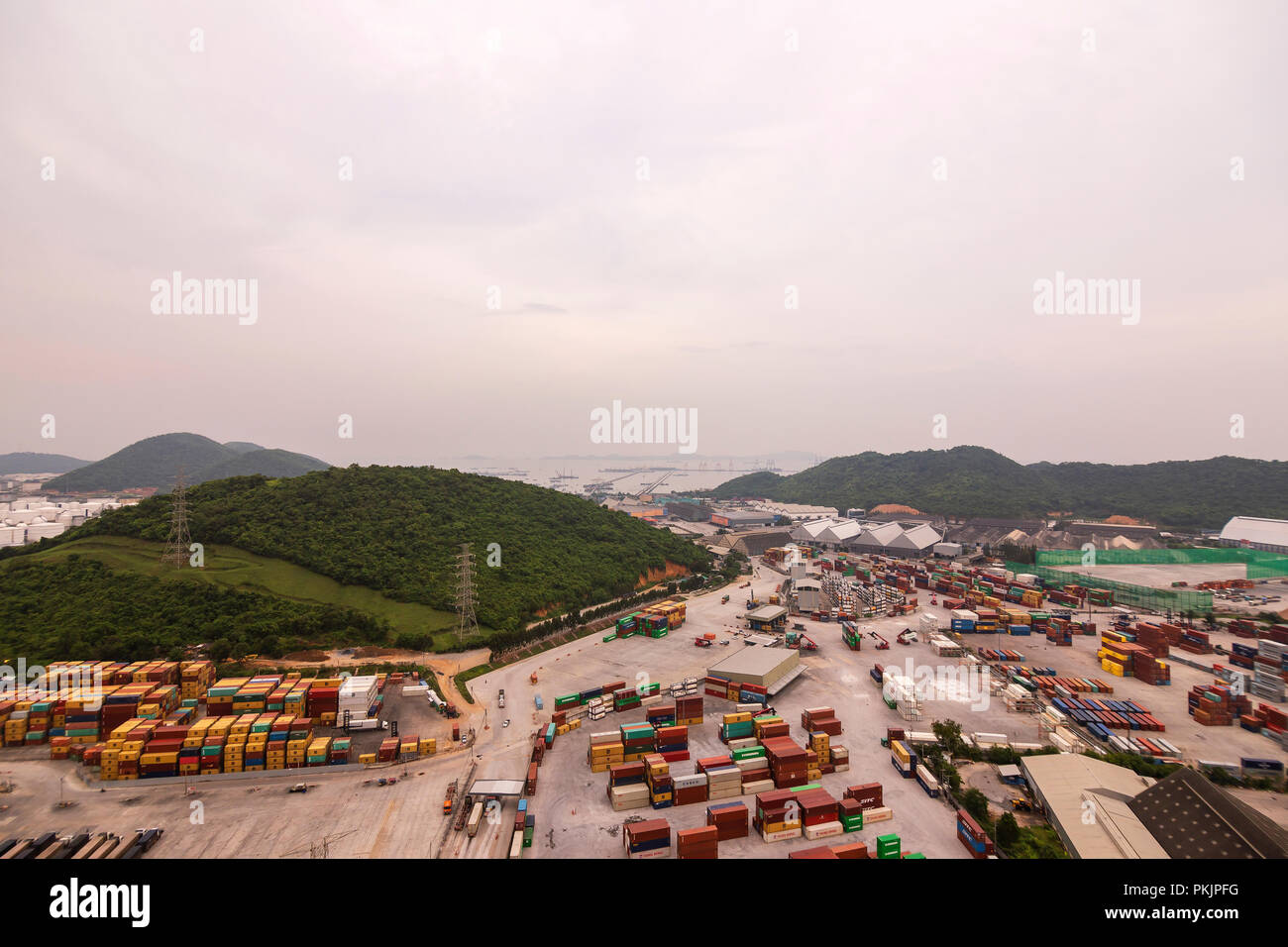 Landscape view of cargo and container field and small hill Stock Photo ...