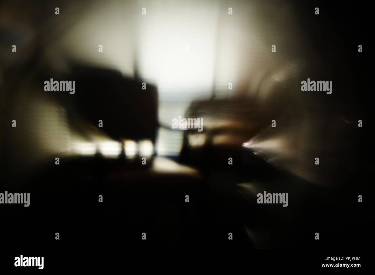 Abstract of an antique chair with venetian blind shadows across it shot ...