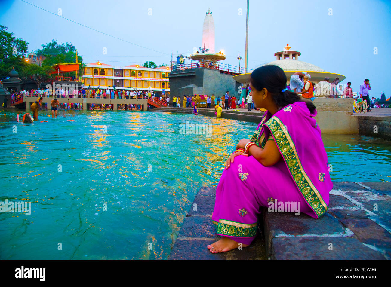 Indian hindu woman sitting on the godavari river bank wearing colour ...
