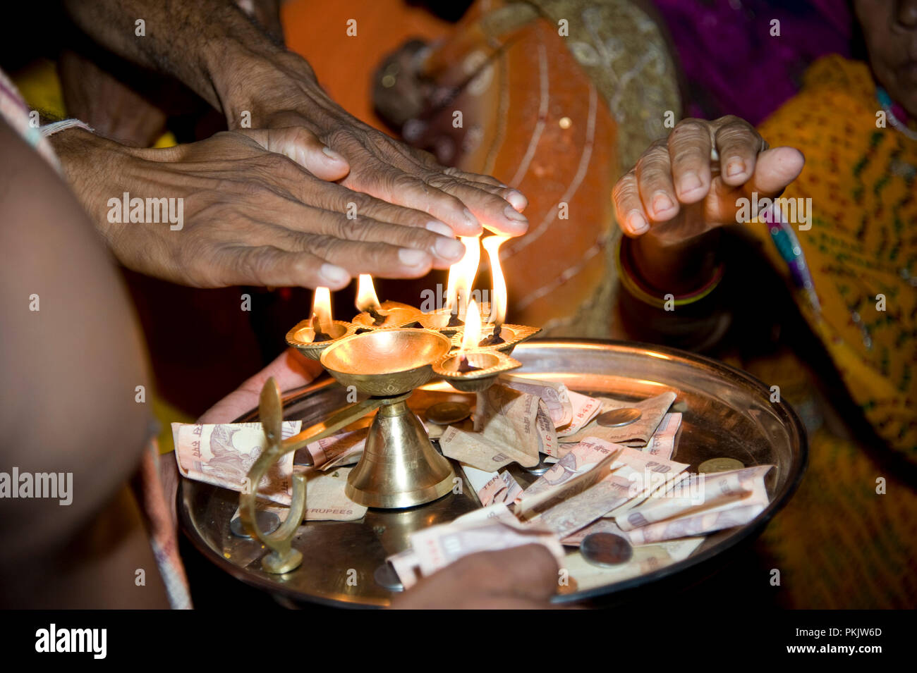 People taking blessings from the holy fire after the aarti of god or ...