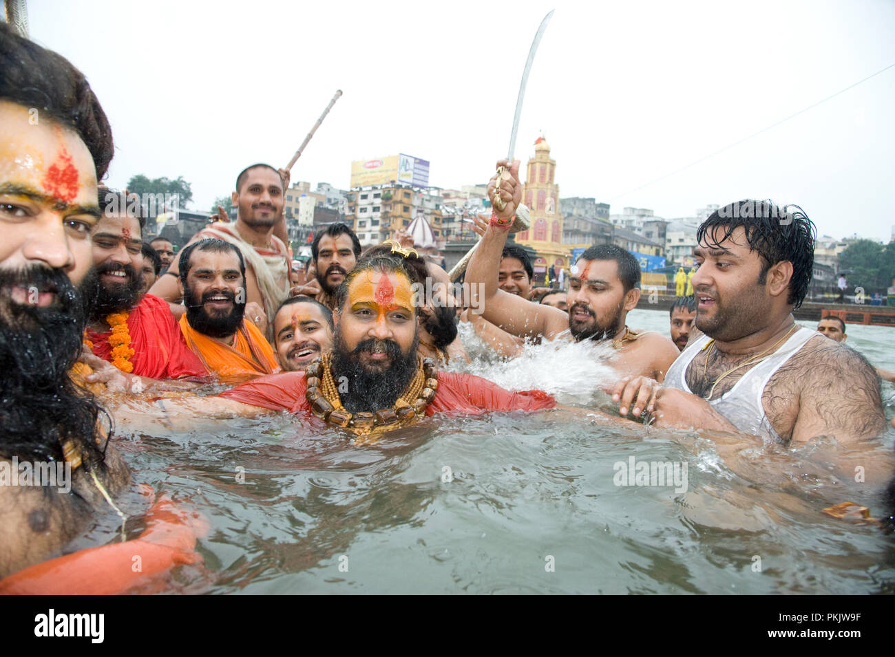 Indian Hindu holy man or sadhu taking holy dip in godavari river at ...