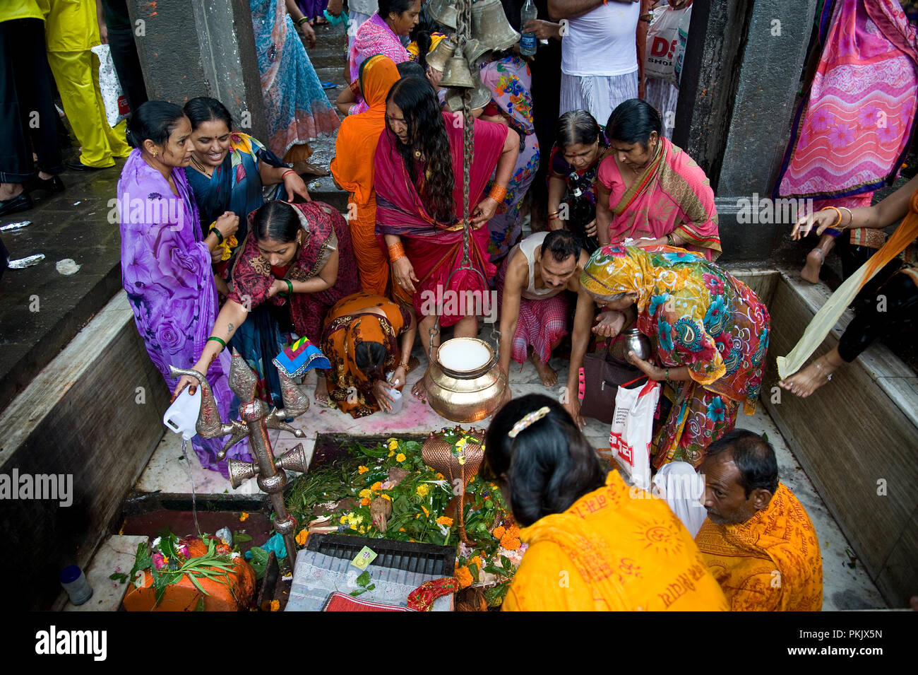 Hindu riligious women offers prayers by pouring milk or water or flower ...