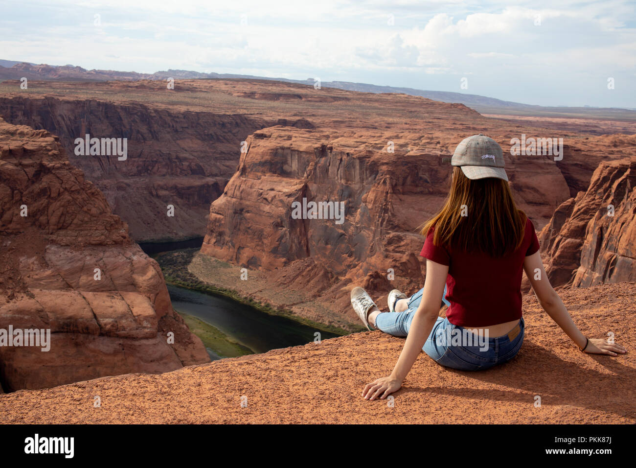 Girl looking over Glen Canyon on the edge of a cliff in the fall Stock ...