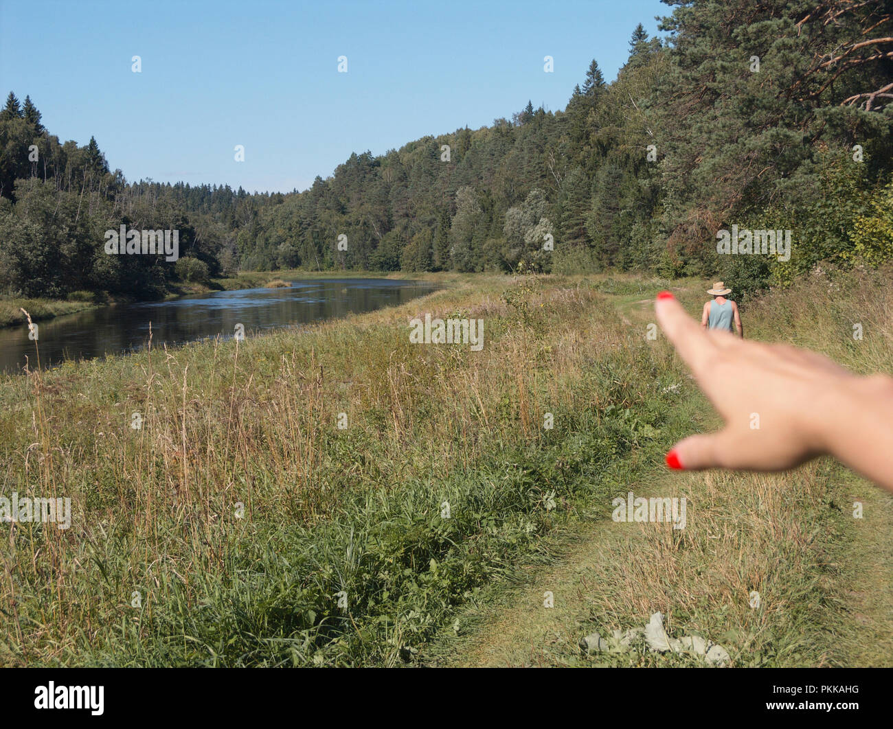 Man walking away and female hand pointing him direction, outdoor ...