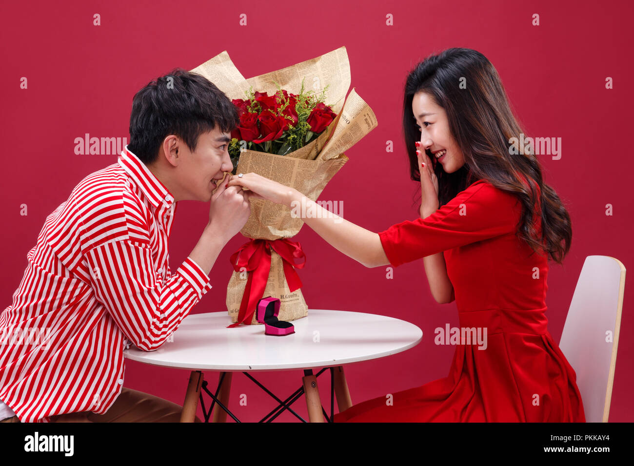 The young man to his girlfriend flowers Stock Photo - Alamy