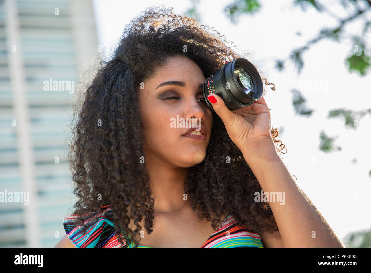 Black woman looking through lens camera hi-res stock photography and ...