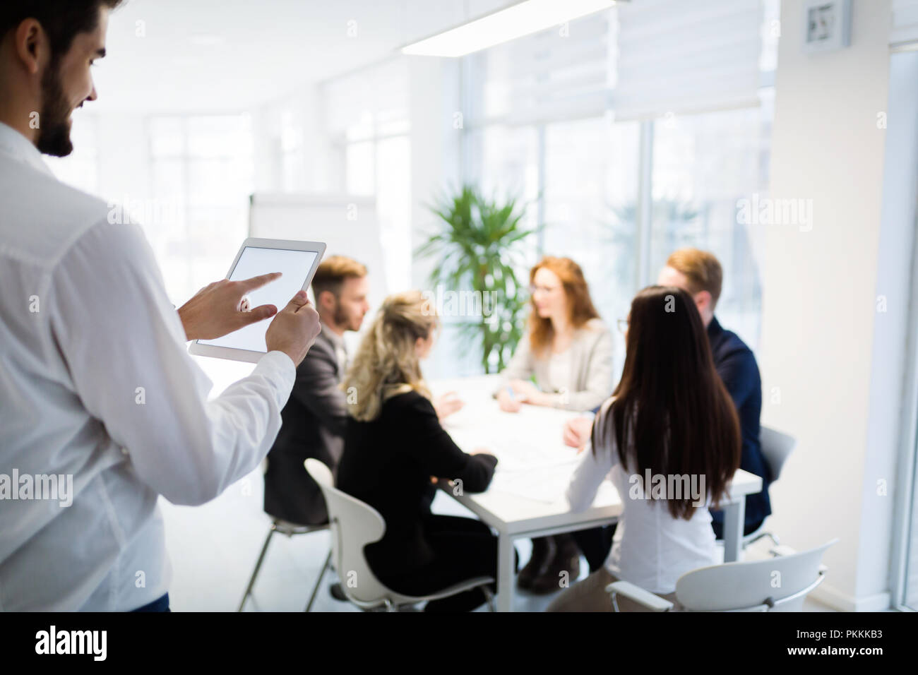 Group of business people collaborating in business office Stock Photo ...
