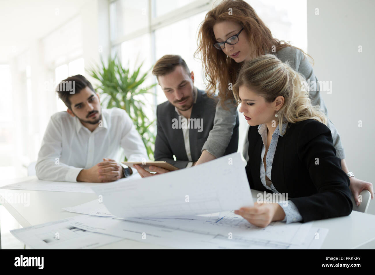 Team of architects working together on project Stock Photo - Alamy
