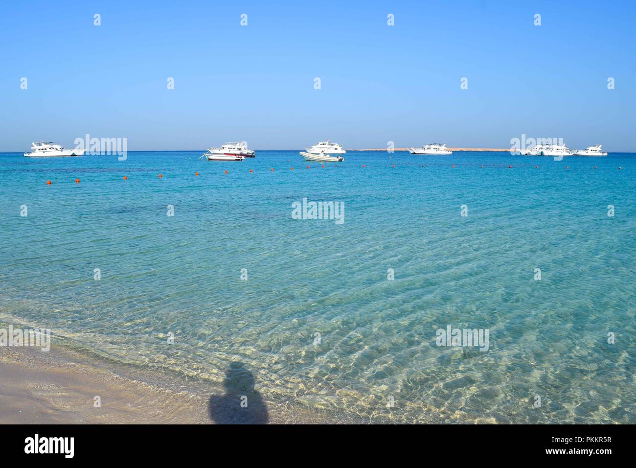 ocean with many boats in front of Mahmya island with turquoise water ...
