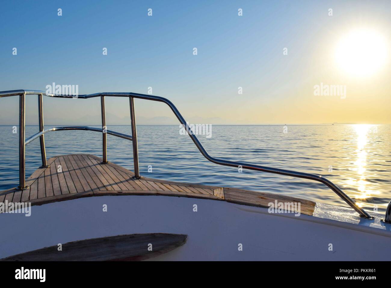 View from yacht over the ocean, horizon in background, blue sky, sunset ...