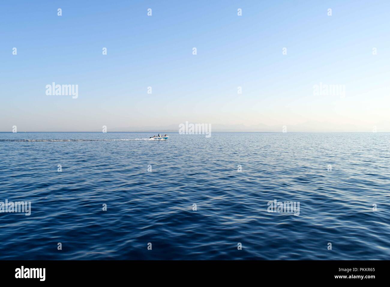 View over red sea,boat travelling in background, blue sky Stock Photo ...