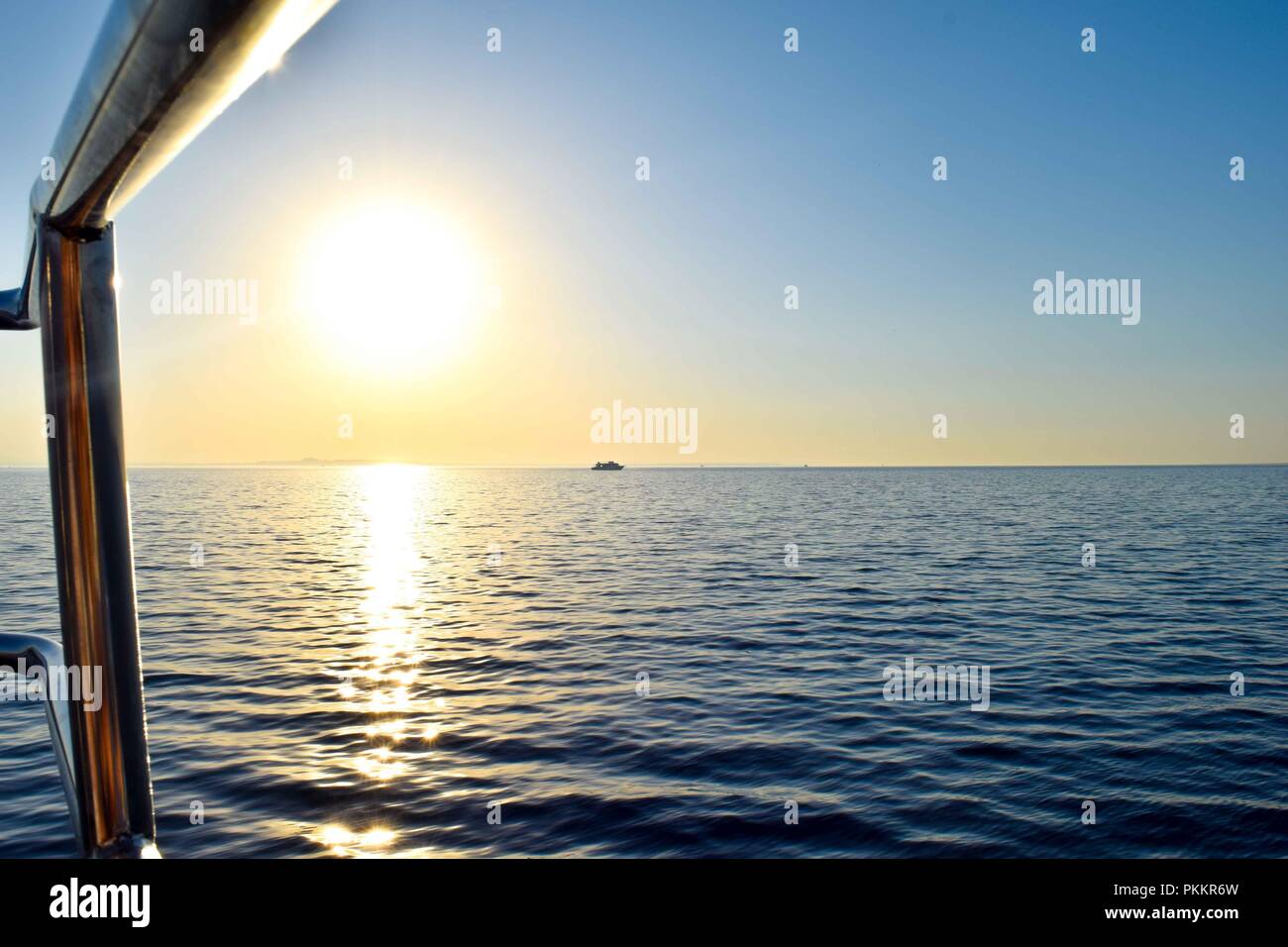View from yacht over the ocean, horizon in background, blue sky, sunset ...