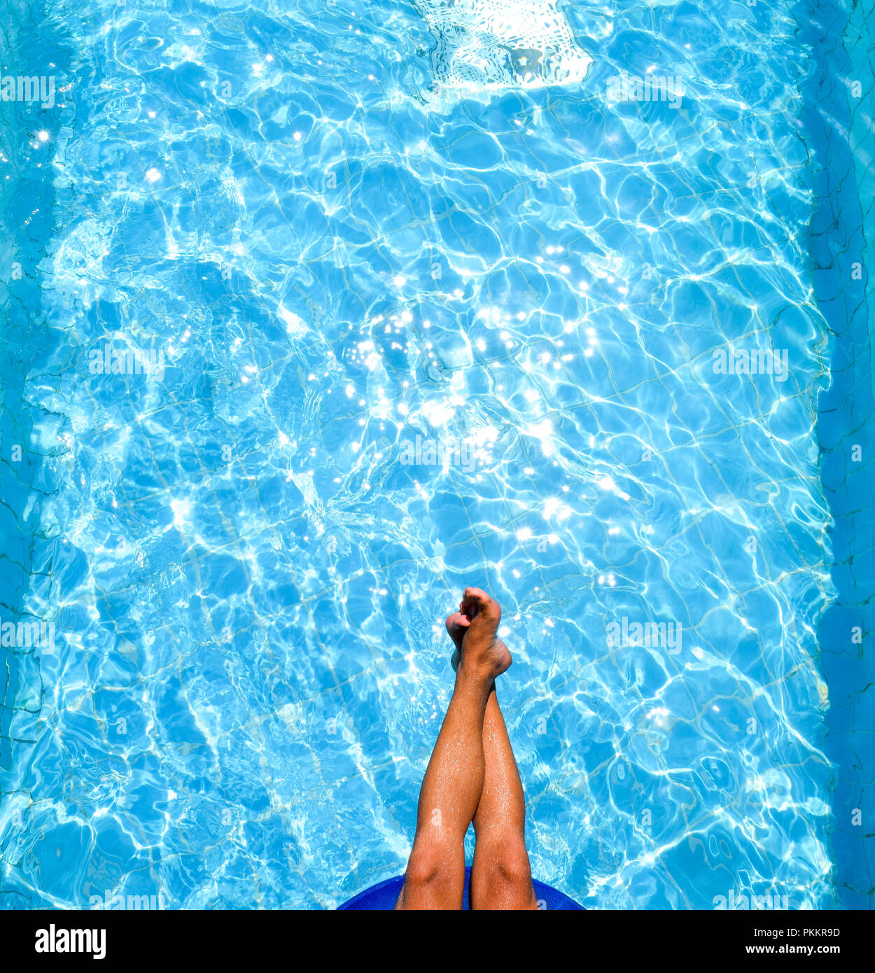 man's feet against blue water of the pool, feet in the pool Stock Photo ...