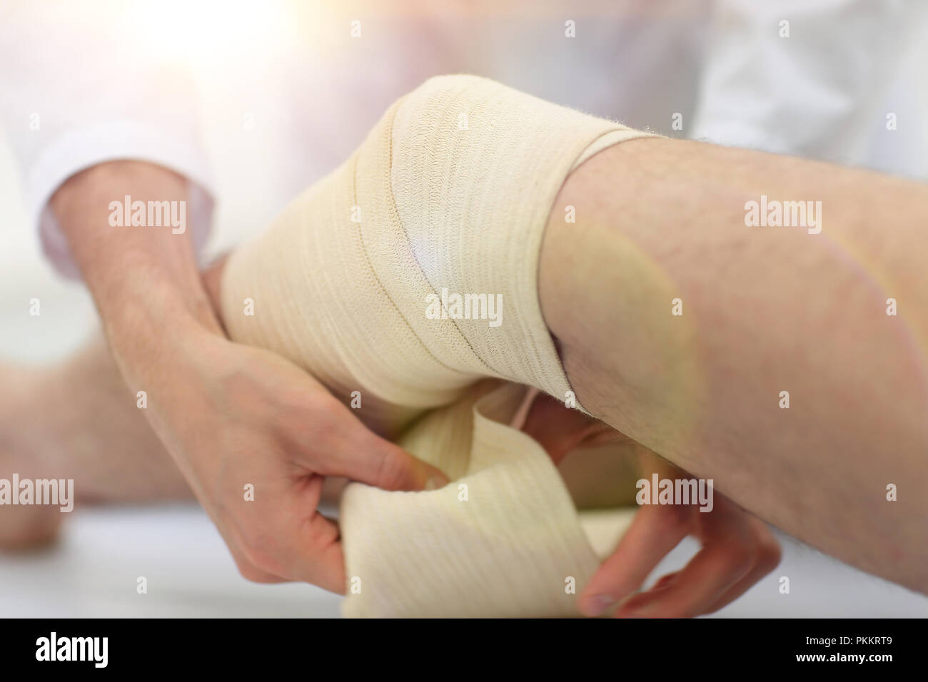 closeup. doctor bandaging a patient's leg Stock Photo - Alamy