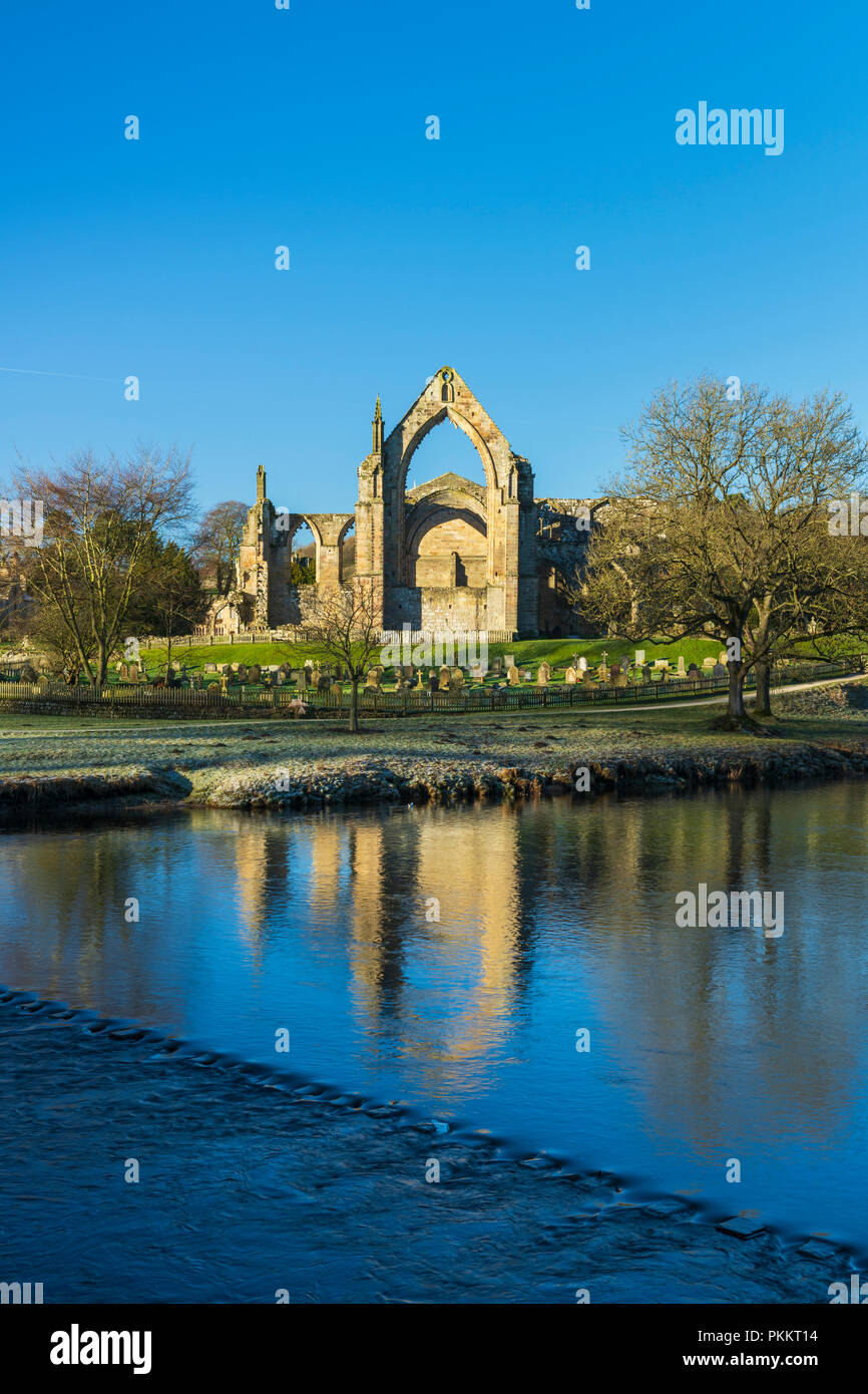 Blue sky & scenic priory ruins of Bolton Abbey reflecting in River ...