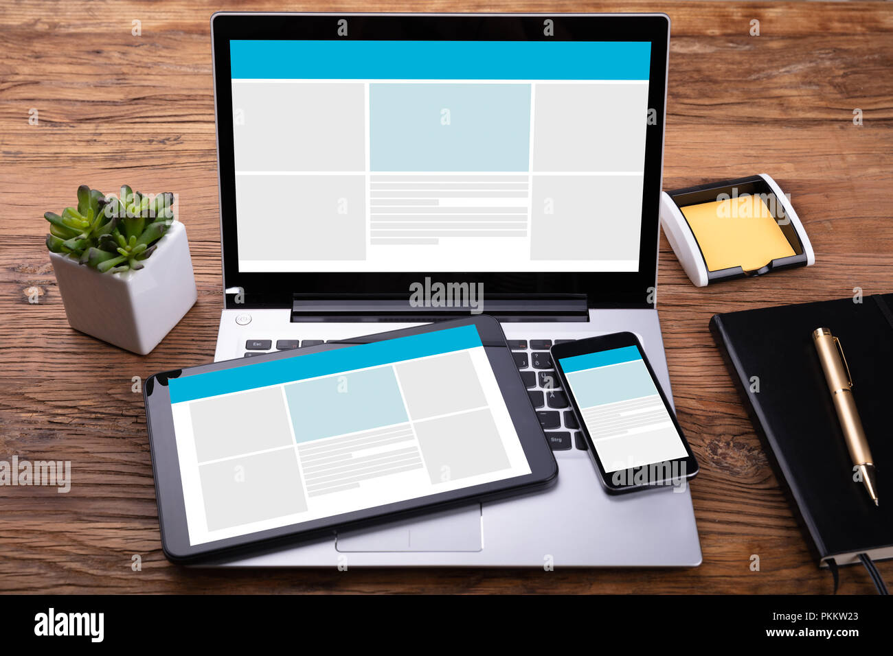 Electronic Devices With Screen On Wooden Desk Near Diary And Pen Stock ...