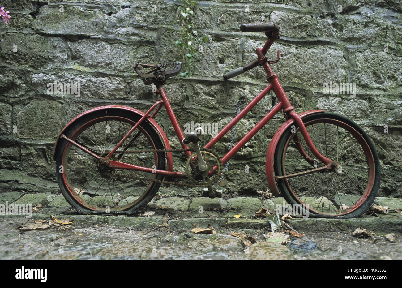 Old broken childs red bicycle Stock Photo - Alamy