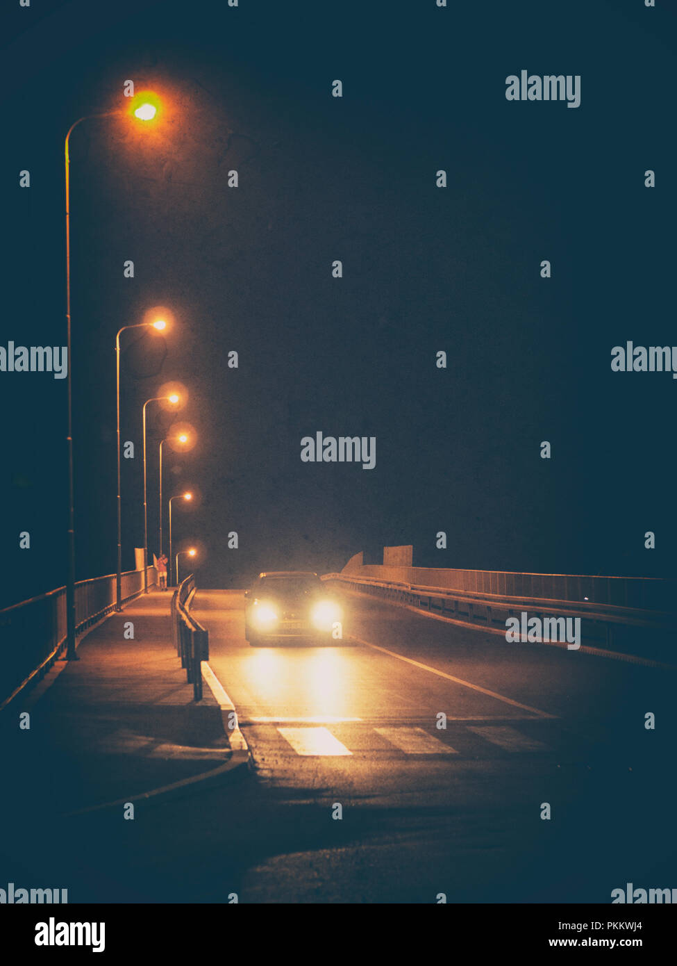 Spooky evening, car on a road Stock Photo - Alamy