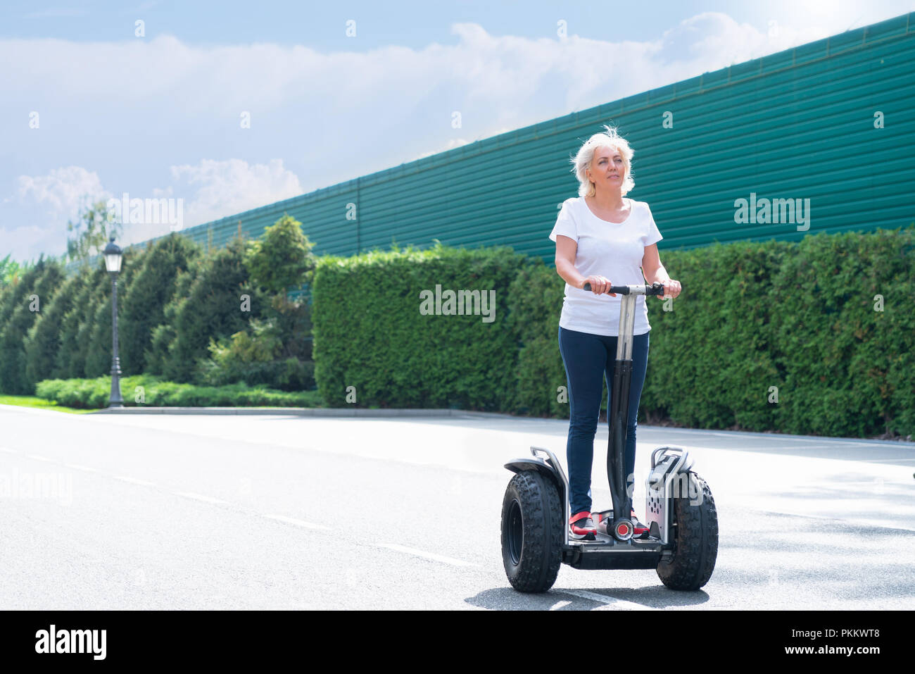 Woman driving electric personal transporter hi-res stock photography ...
