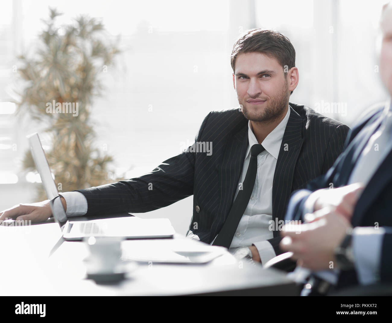 Boss sitting behind desk hi-res stock photography and images - Alamy