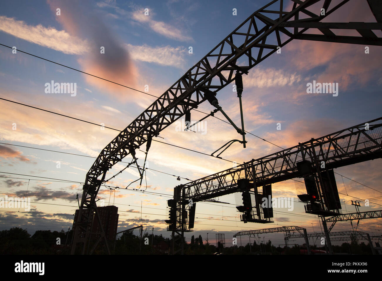 Electric train cables and pylons on Crewe station at sunset, Cheshire ...