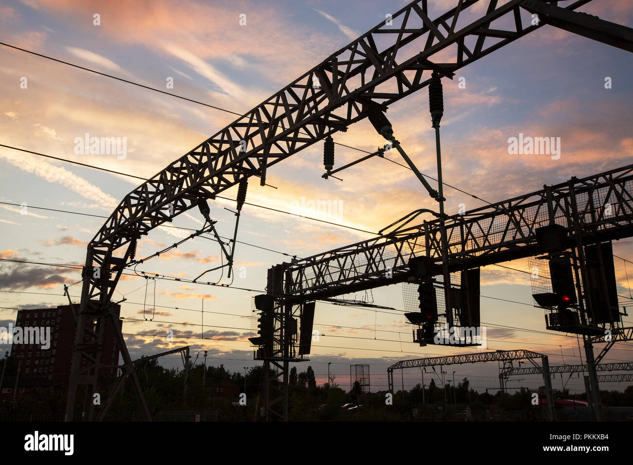 Electric train cables and pylons on Crewe station at sunset, Cheshire ...