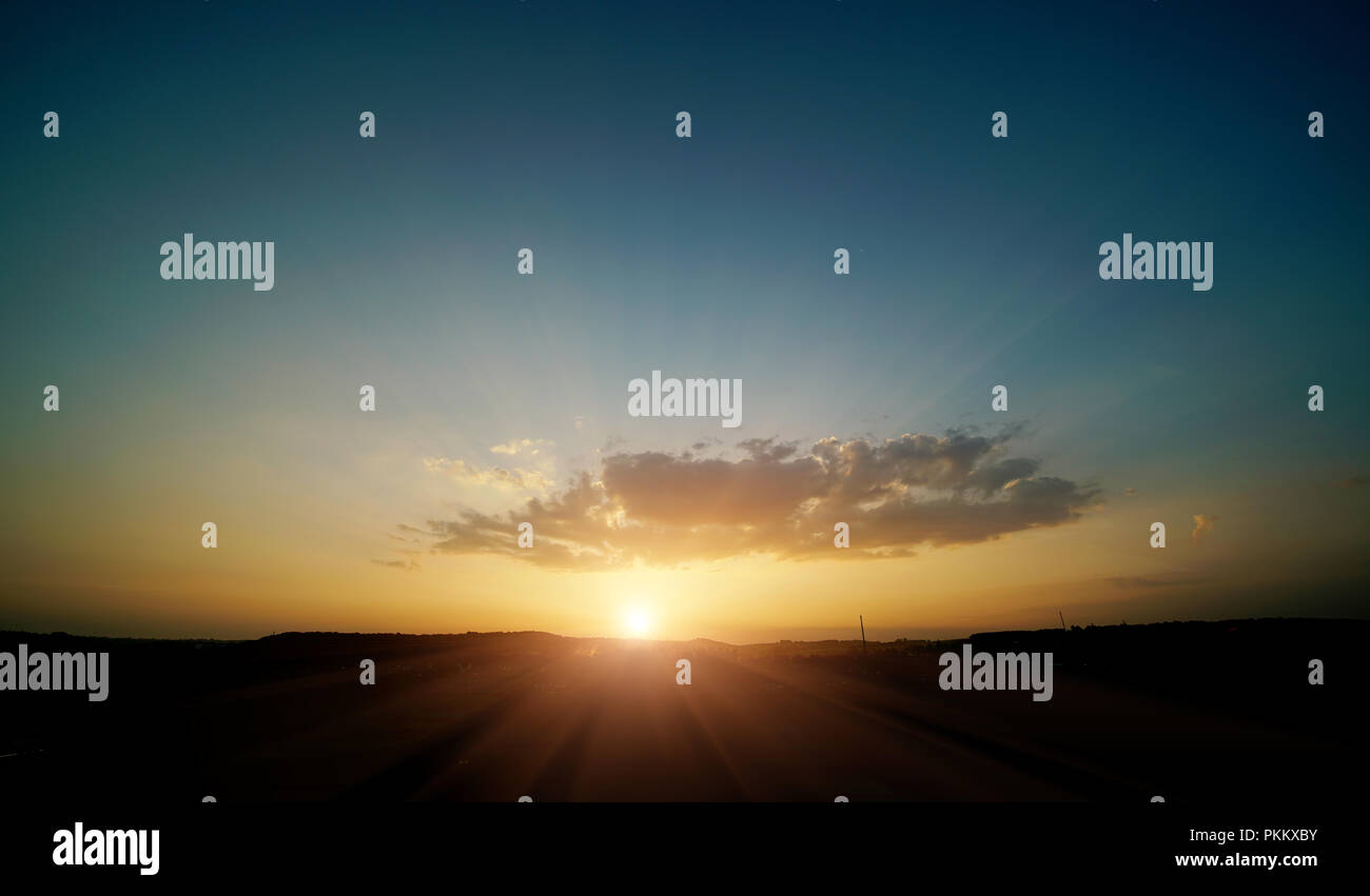 Beautiful sunset sky above clouds with dramatic light Stock Photo - Alamy