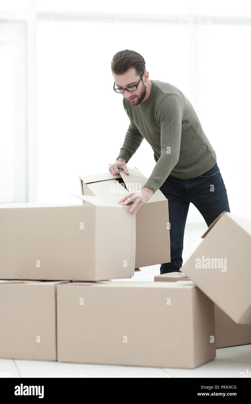confident man unpacking boxes in the new house Stock Photo - Alamy