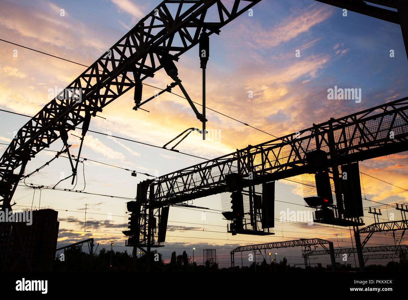 Electric train cables and pylons on Crewe station at sunset, Cheshire ...