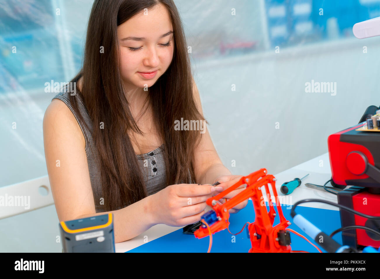 Girl schoolgirl in the classroom in the laboratory of robotics and ...