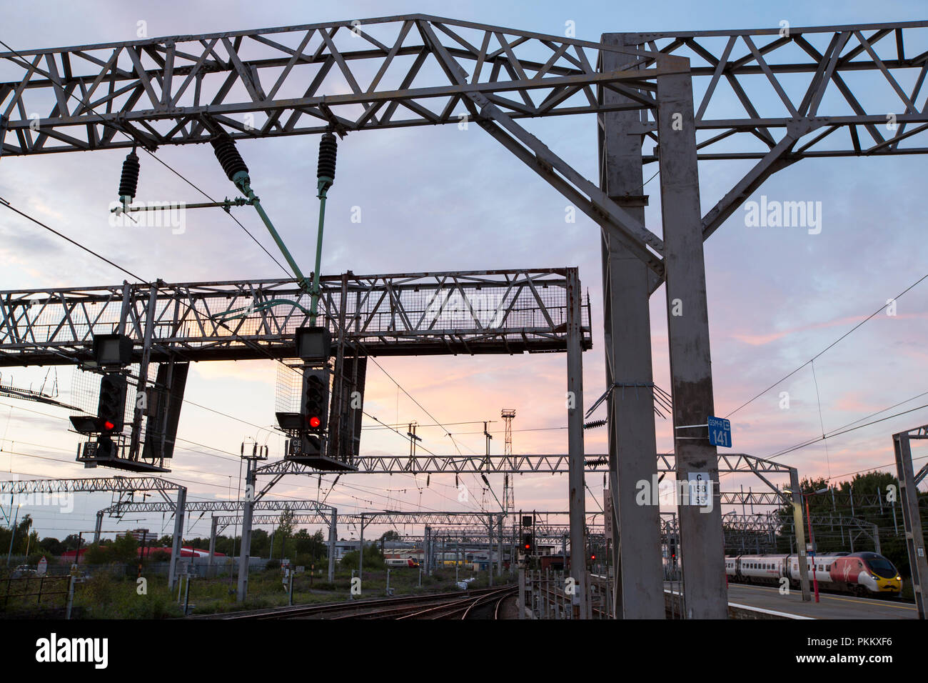 Electric train cables and pylons on Crewe station at sunset, Cheshire ...