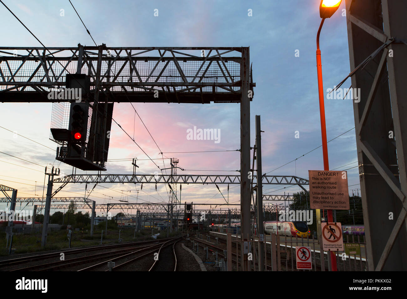 Electric train cables and pylons on Crewe station at sunset, Cheshire ...
