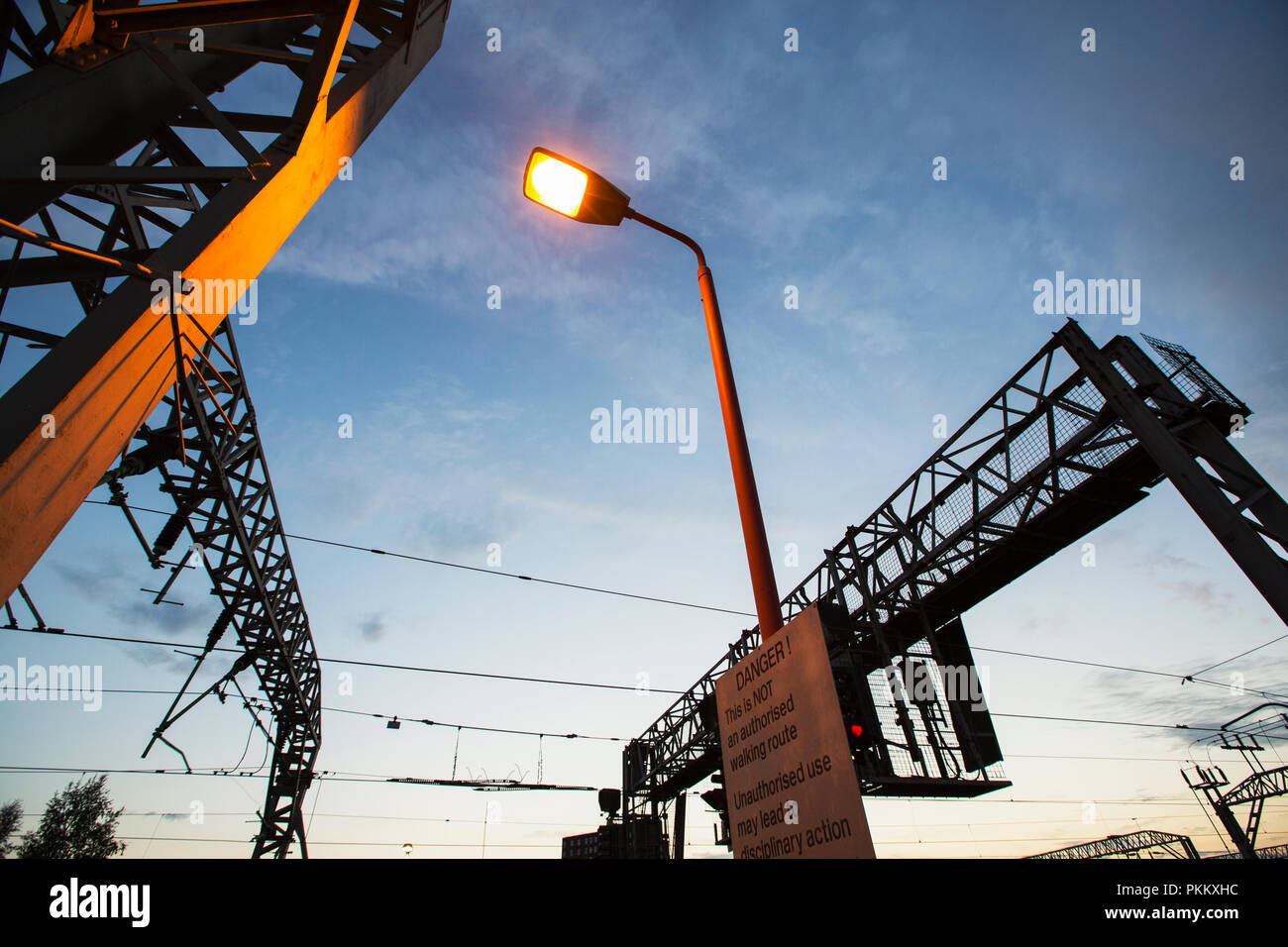 Electric train cables and pylons on Crewe station at sunset, Cheshire ...