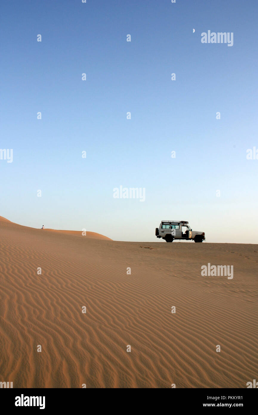 Egyptian Berber praying next to his off-road vehicle during a Sahara ...