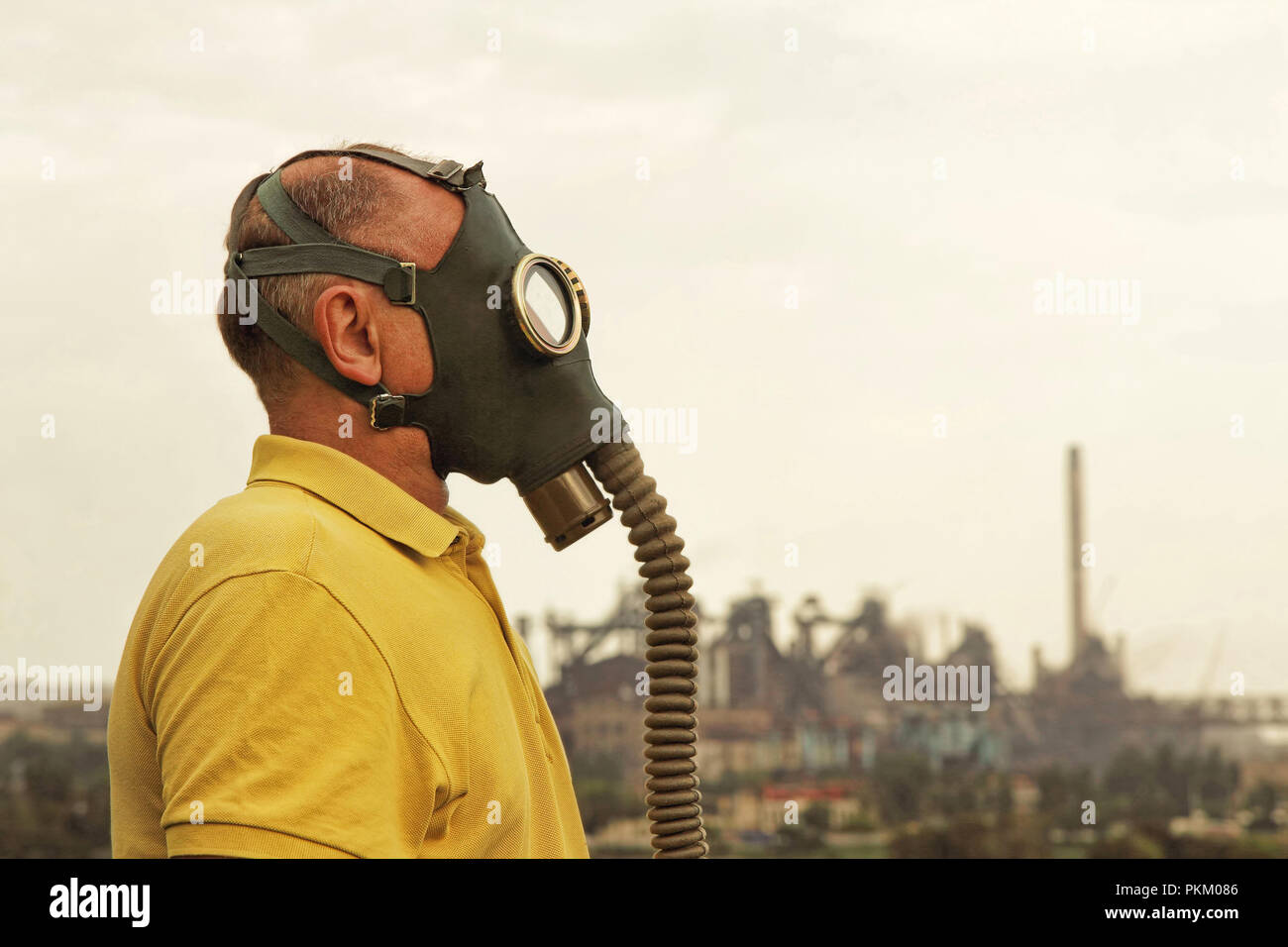 Men in gas mask. View of the industrial factory. Toned image Stock ...