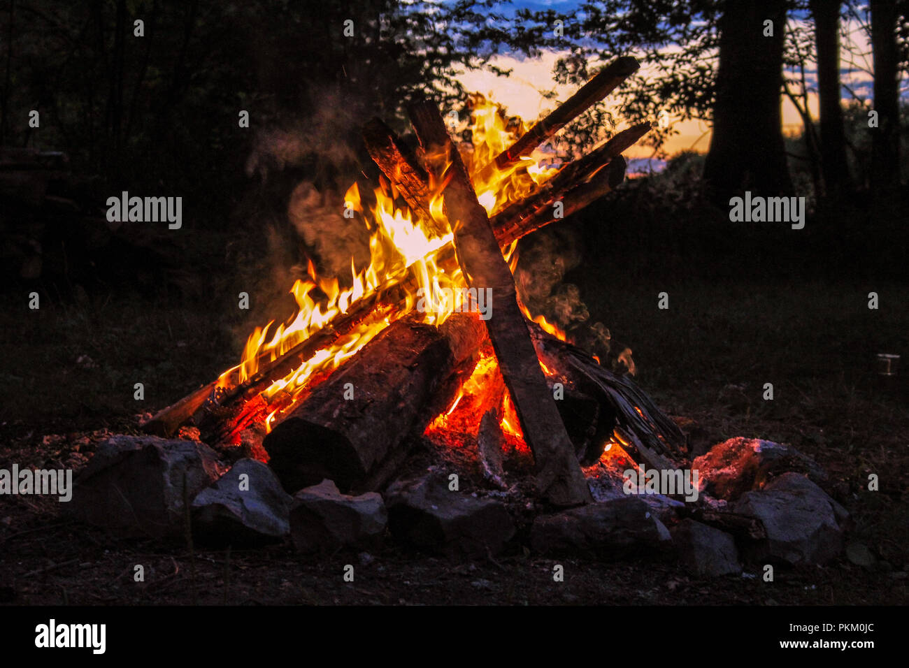 glowing camping fire at night Stock Photo - Alamy