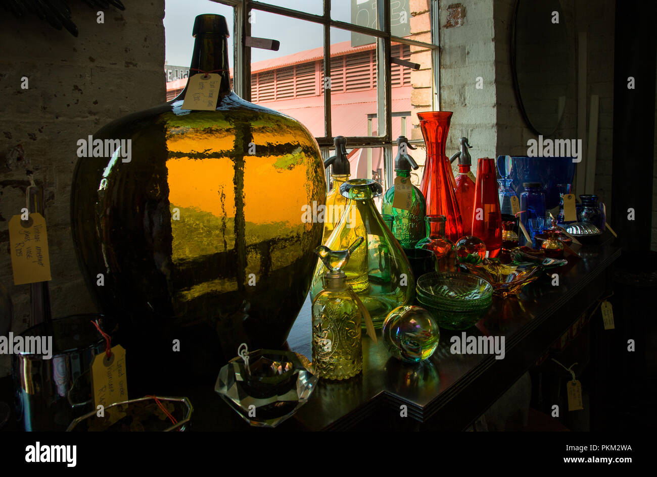 A display of objects made of glass of different colors Stock Photo - Alamy