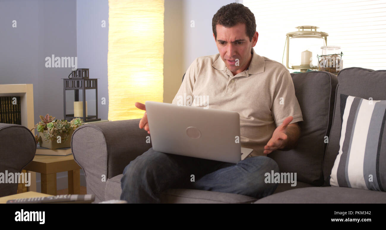 Man watching sports game on his laptop Stock Photo - Alamy