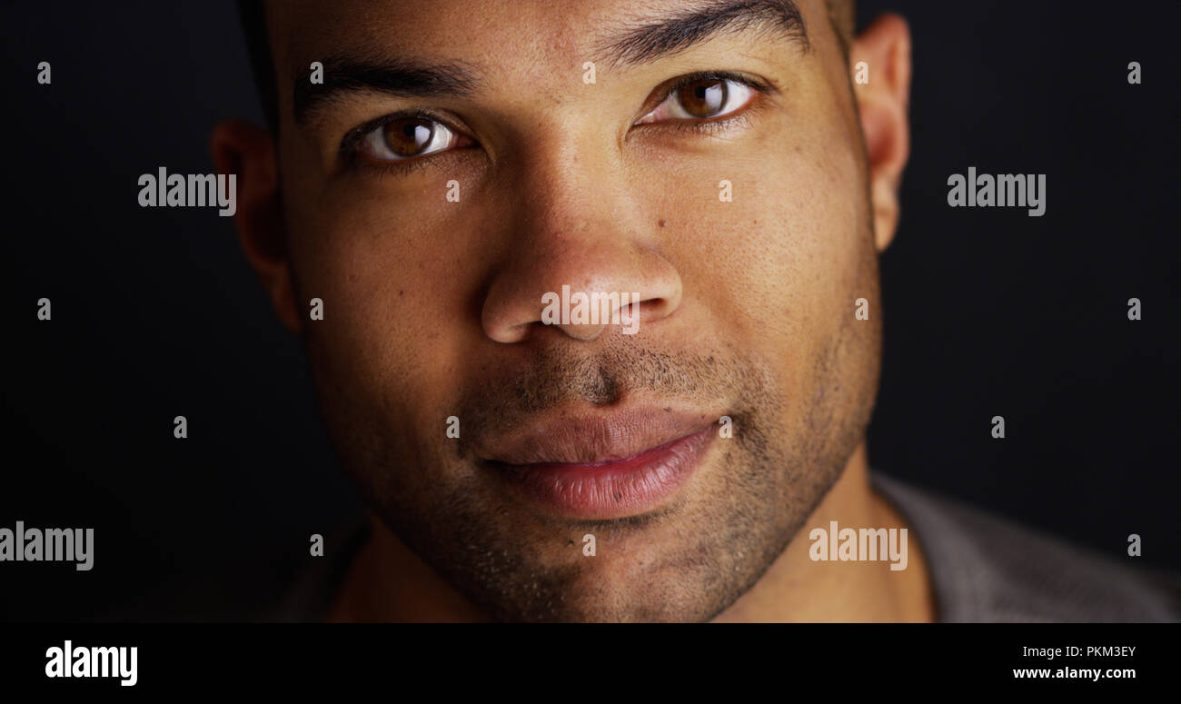 Handsome black man looking at camera Stock Photo - Alamy