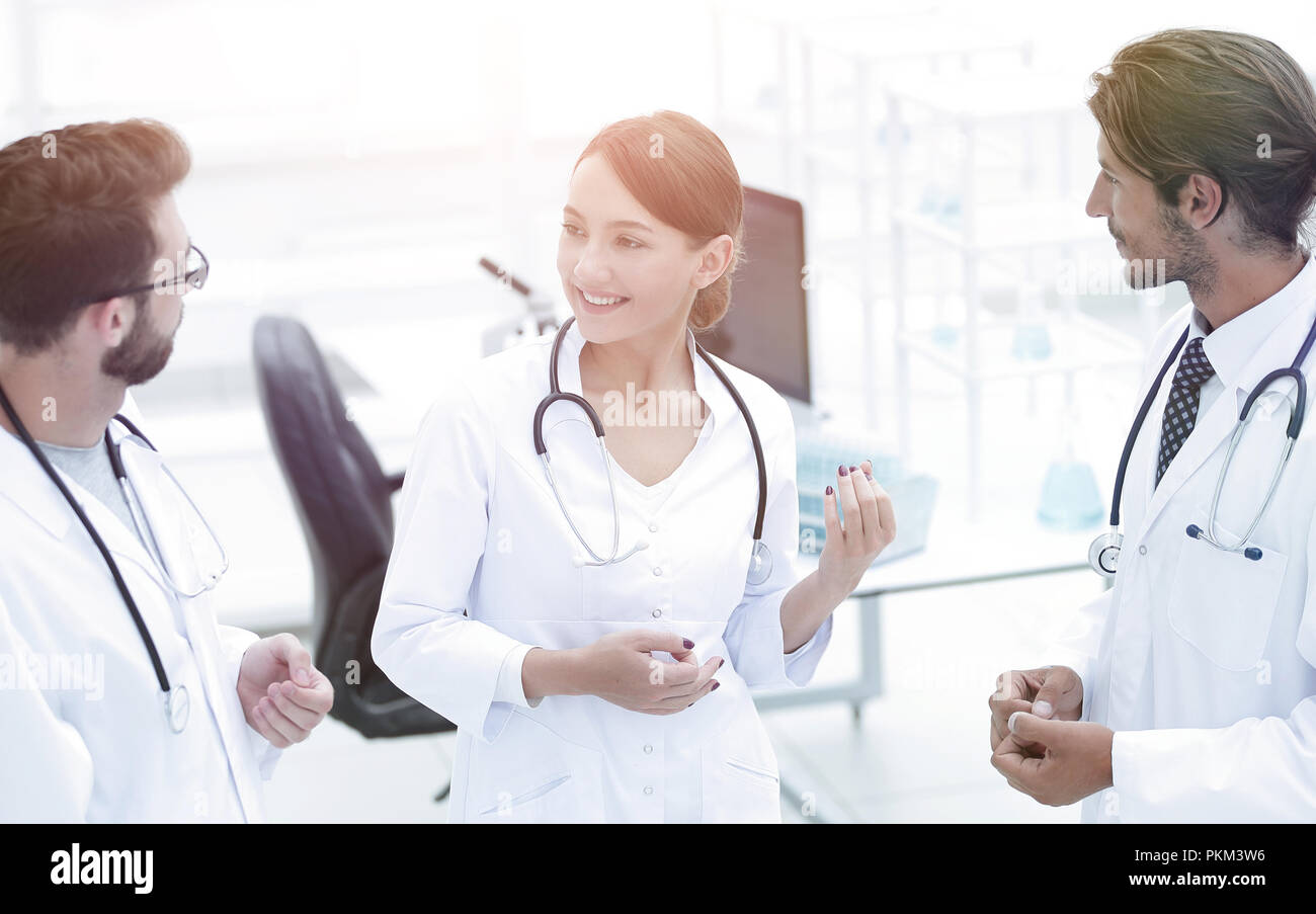 Team of different doctors having conversation Stock Photo - Alamy
