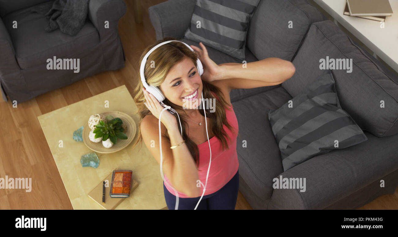 Pretty girl dancing to music with smartphone Stock Photo - Alamy