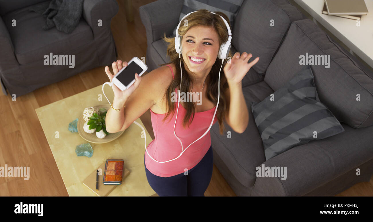 Beautiful young woman dancing with headphones Stock Photo - Alamy
