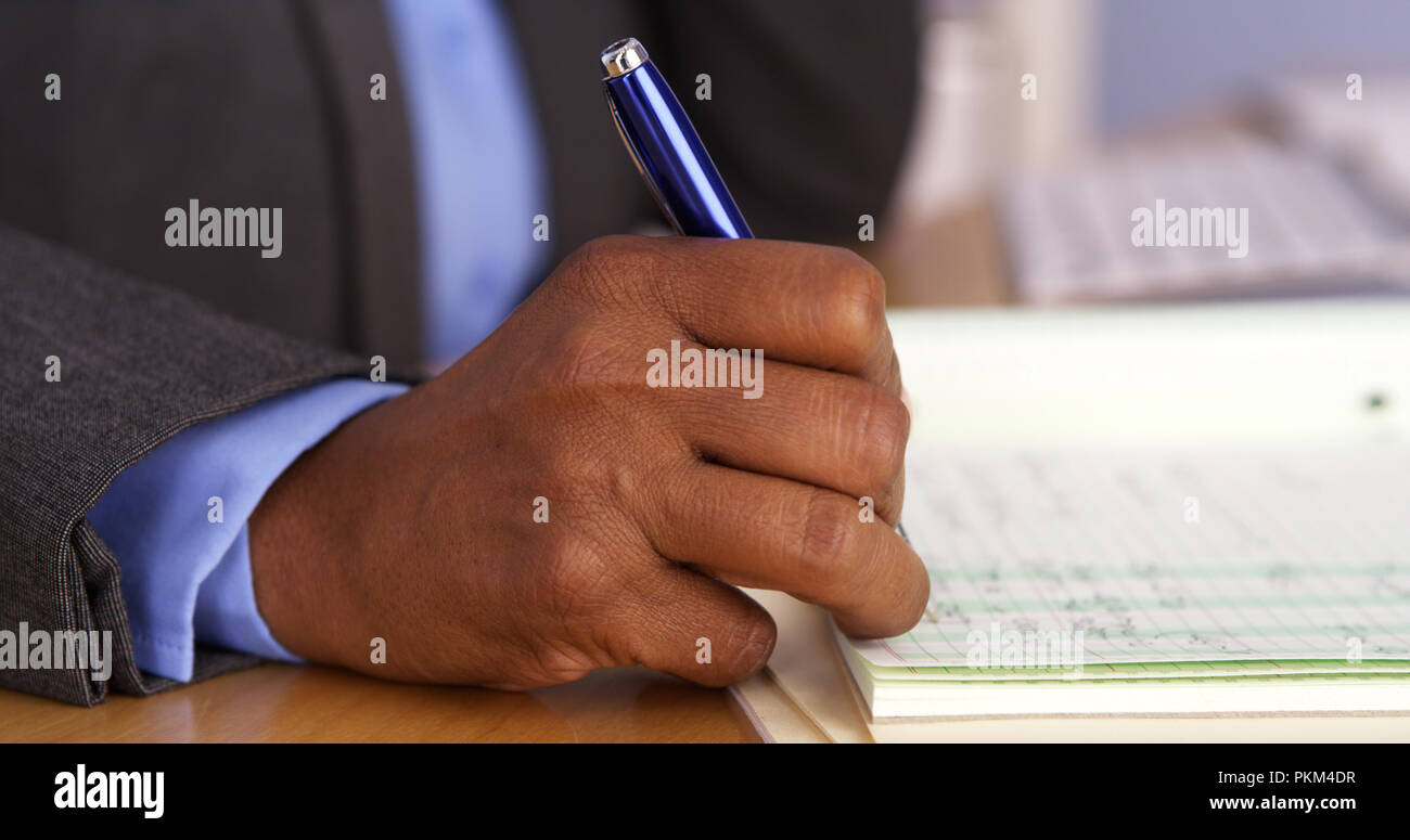 Senior black businesswoman taking notes on pad Stock Photo - Alamy