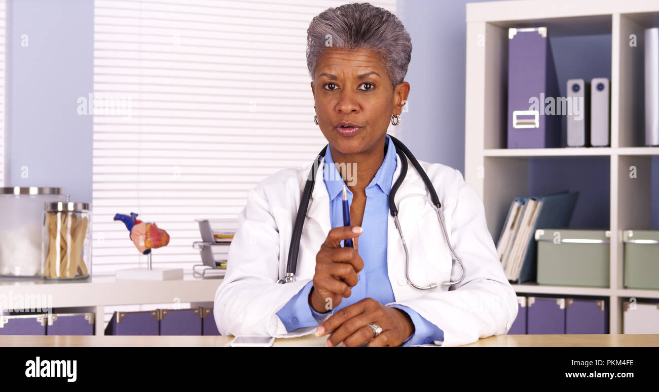 African senior doctor talking camera hi-res stock photography and ...