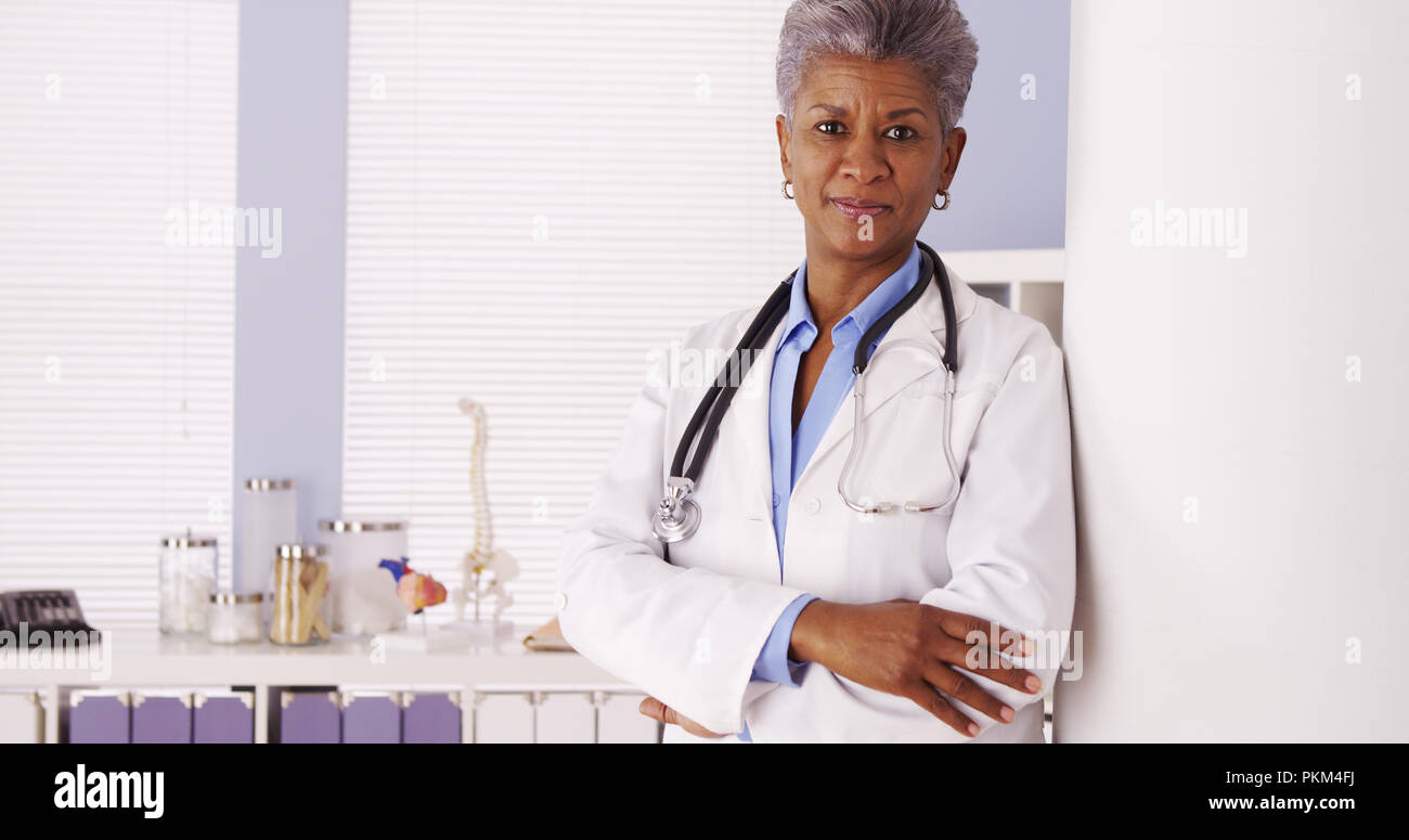 African Senior doctor standing in office Stock Photo - Alamy