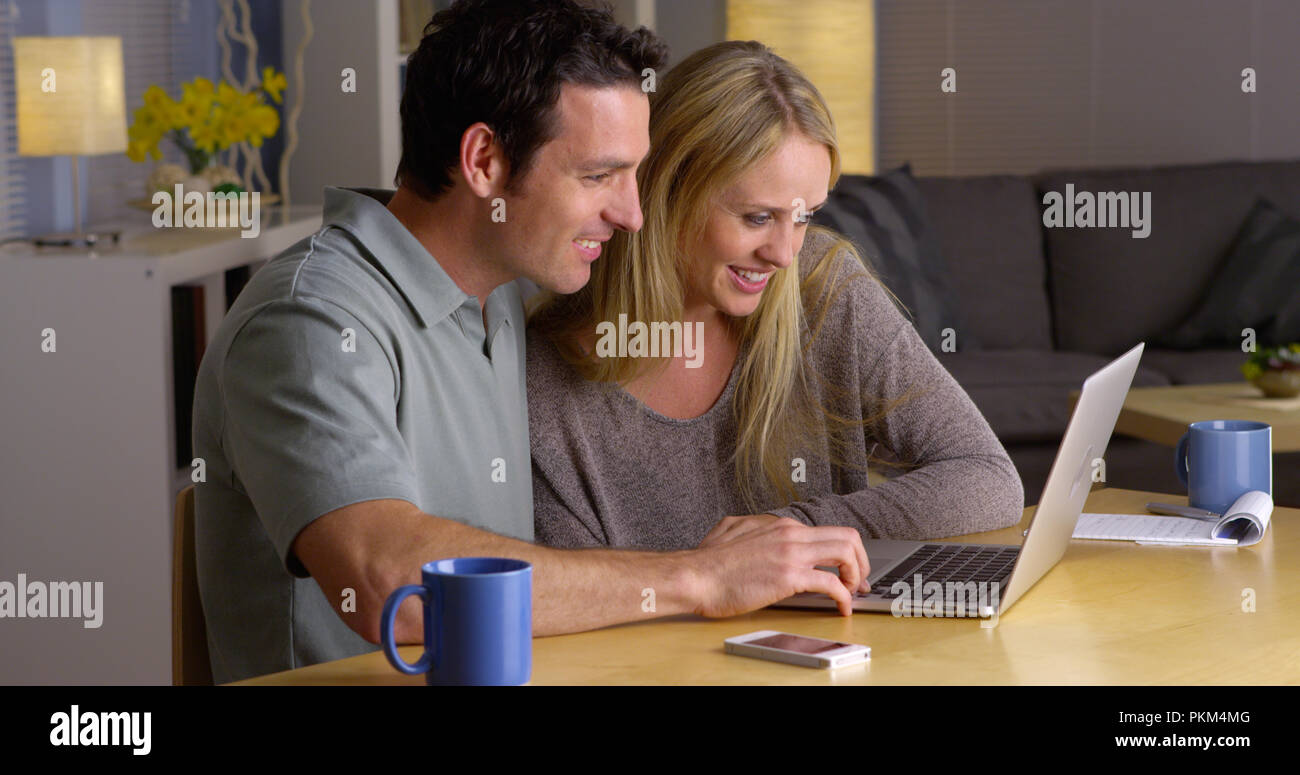 Happy couple surfing the internet together Stock Photo - Alamy