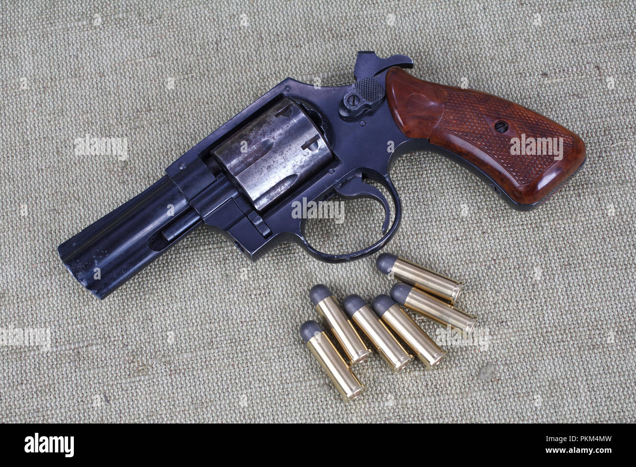 Revolver with ammunition on the canvas background Stock Photo - Alamy