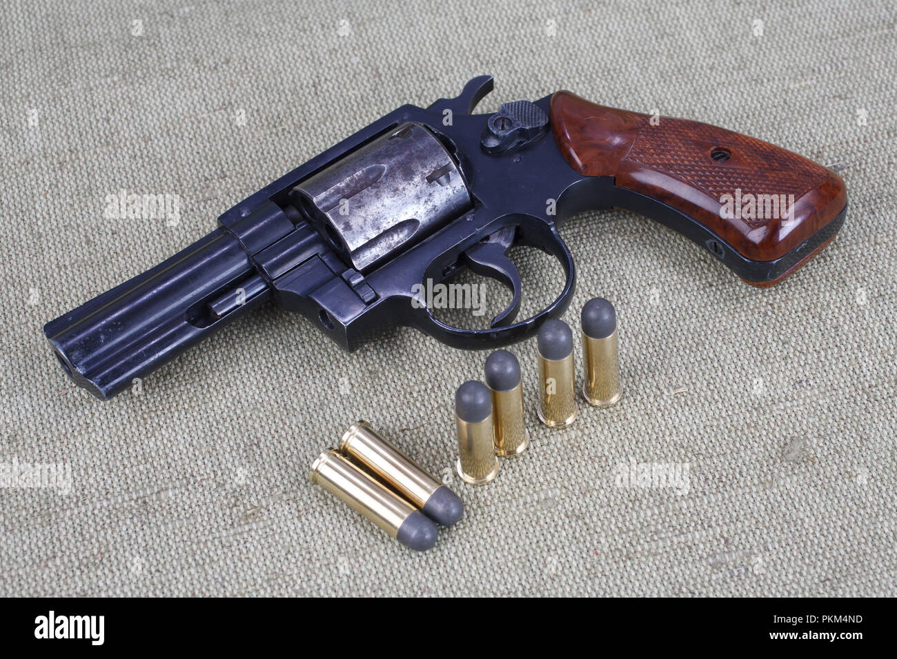 Revolver with ammunition on the canvas background Stock Photo - Alamy